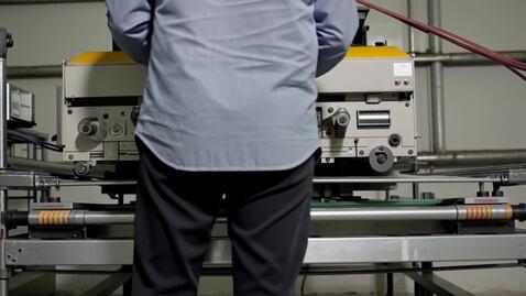 an employee with his back turned working on a ca