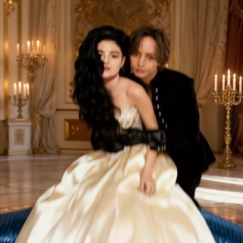 A man and a woman mount a huge blue dragon with