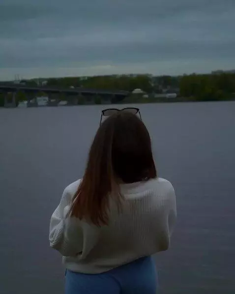 The girl turns her back, bends forward, shows he