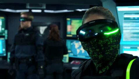 Interior: A dim, high-tech command center aboard